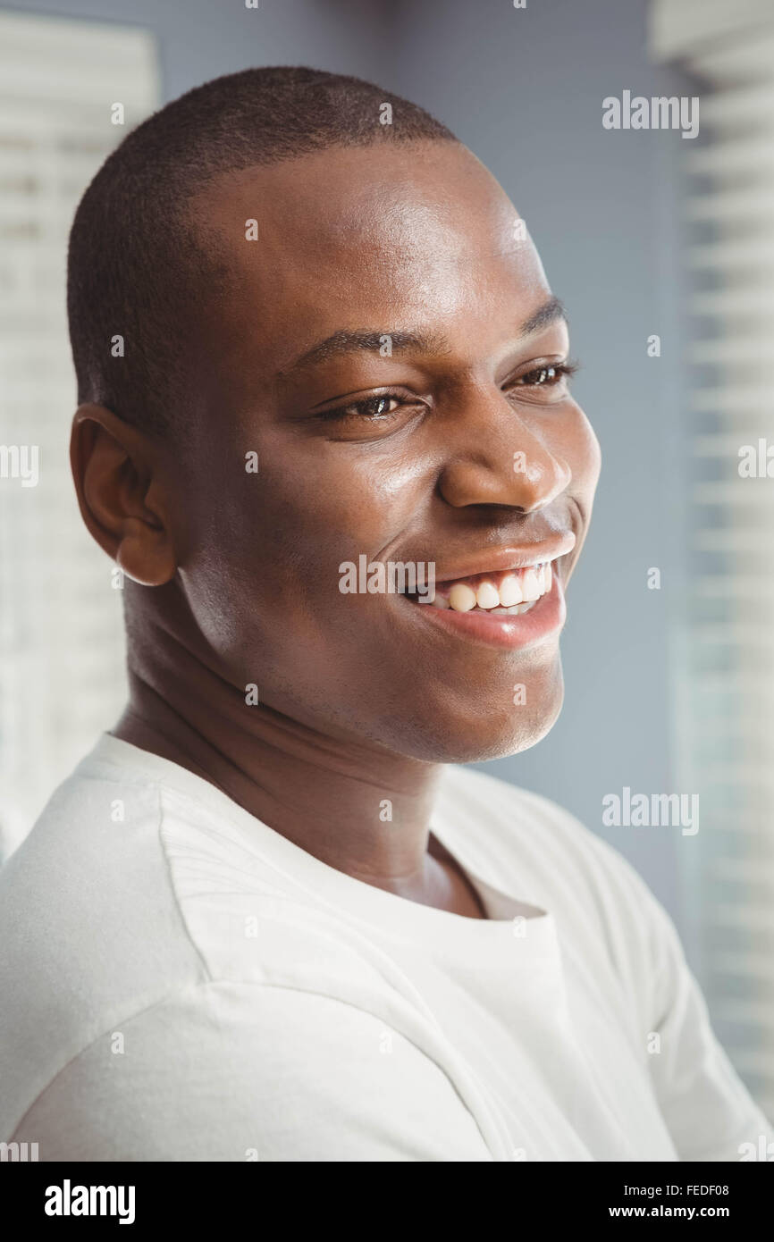 Smiling man looking through the window Stock Photo - Alamy
