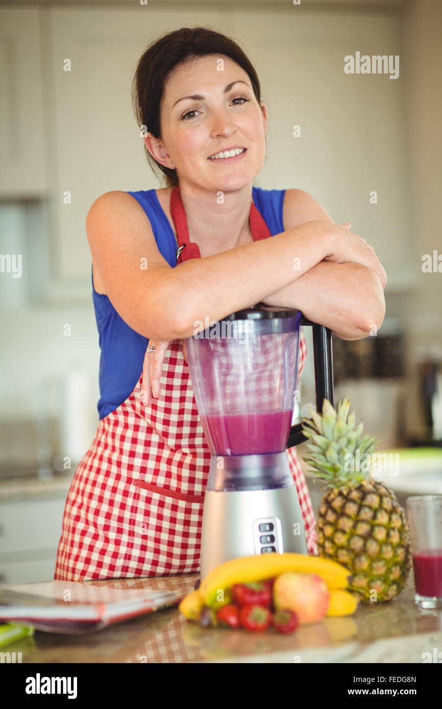 Woman leaning hand on mixer Stock Photo - Alamy