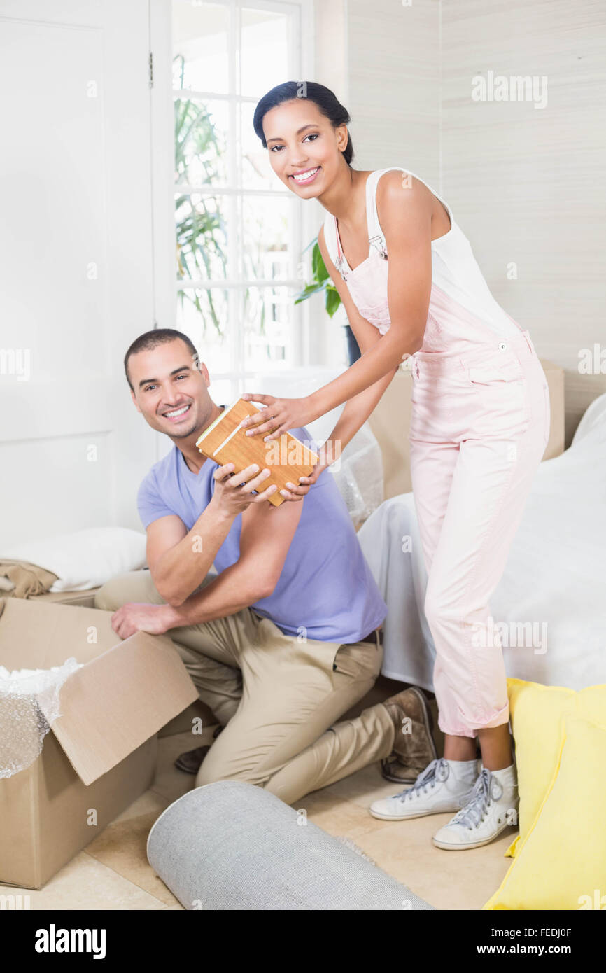 Happy couple unpacking after move Stock Photo - Alamy