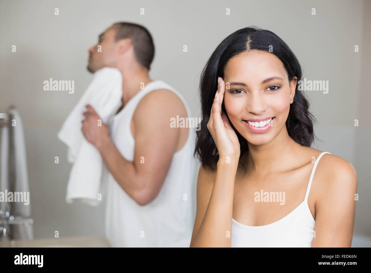 Smiling couple looking at mirror Stock Photo - Alamy