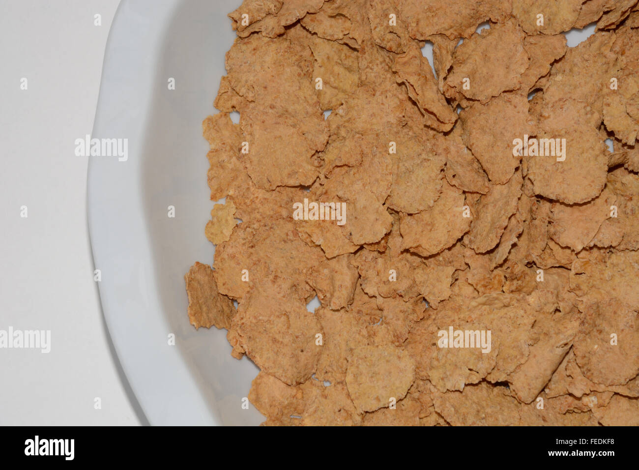 Dry whole wheat flake cereal in bowl Stock Photo - Alamy