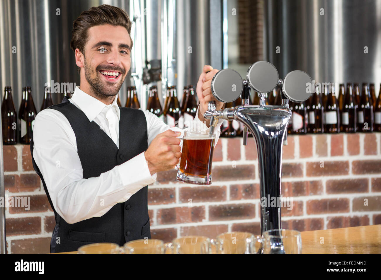 Handsome barman pouring a pint of beer Stock Photo - Alamy