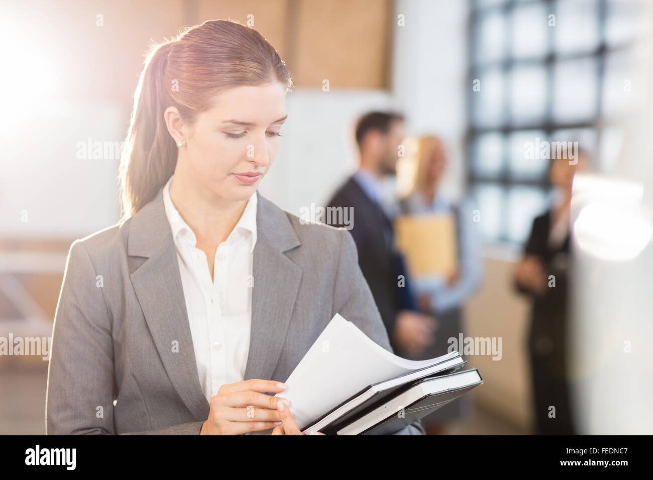 Businesswoman reading through documents Stock Photo - Alamy