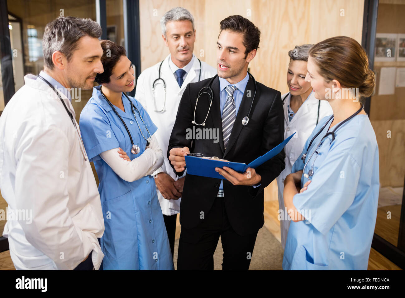 Medical team standing and talking Stock Photo - Alamy
