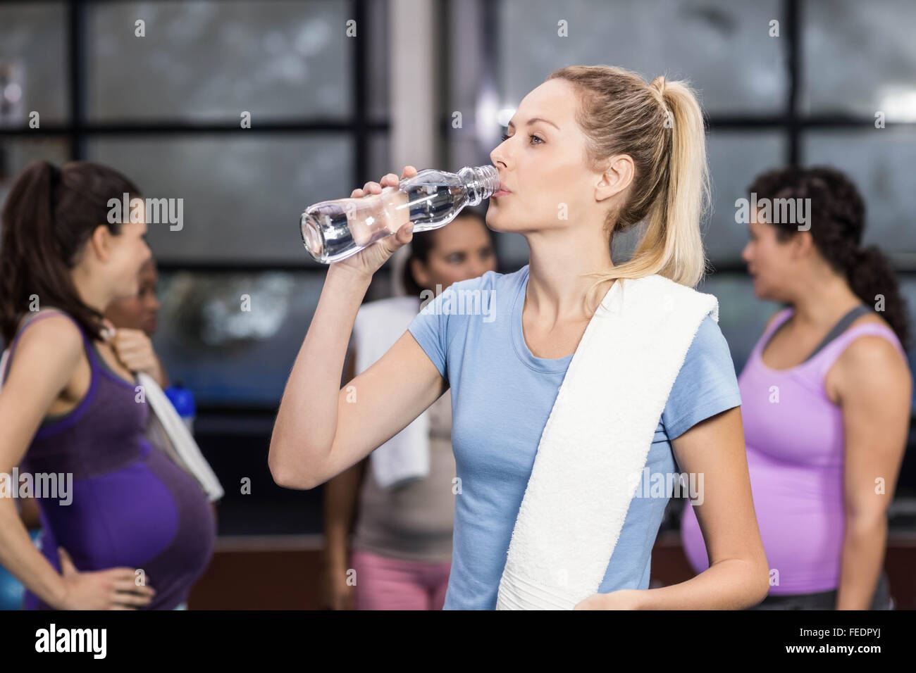 Female trainer drinking water Stock Photo - Alamy
