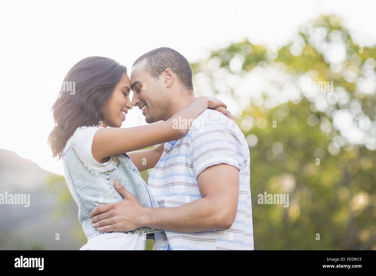 Happy young couple hugging Stock Photo - Alamy
