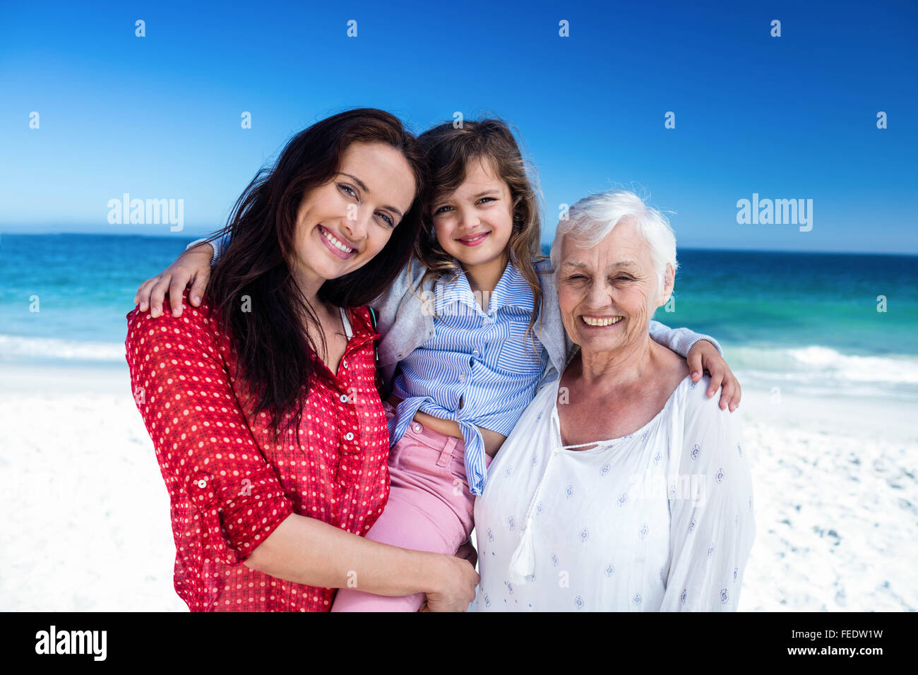 Multi generation family hugging and smiling Stock Photo - Alamy