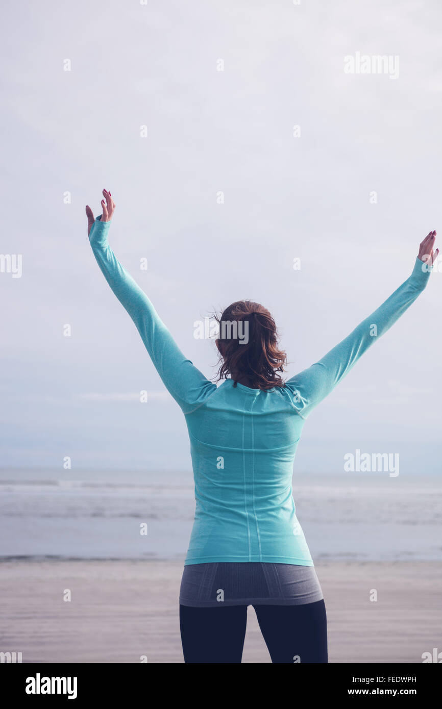 Fit brunette raising her arms Stock Photo - Alamy