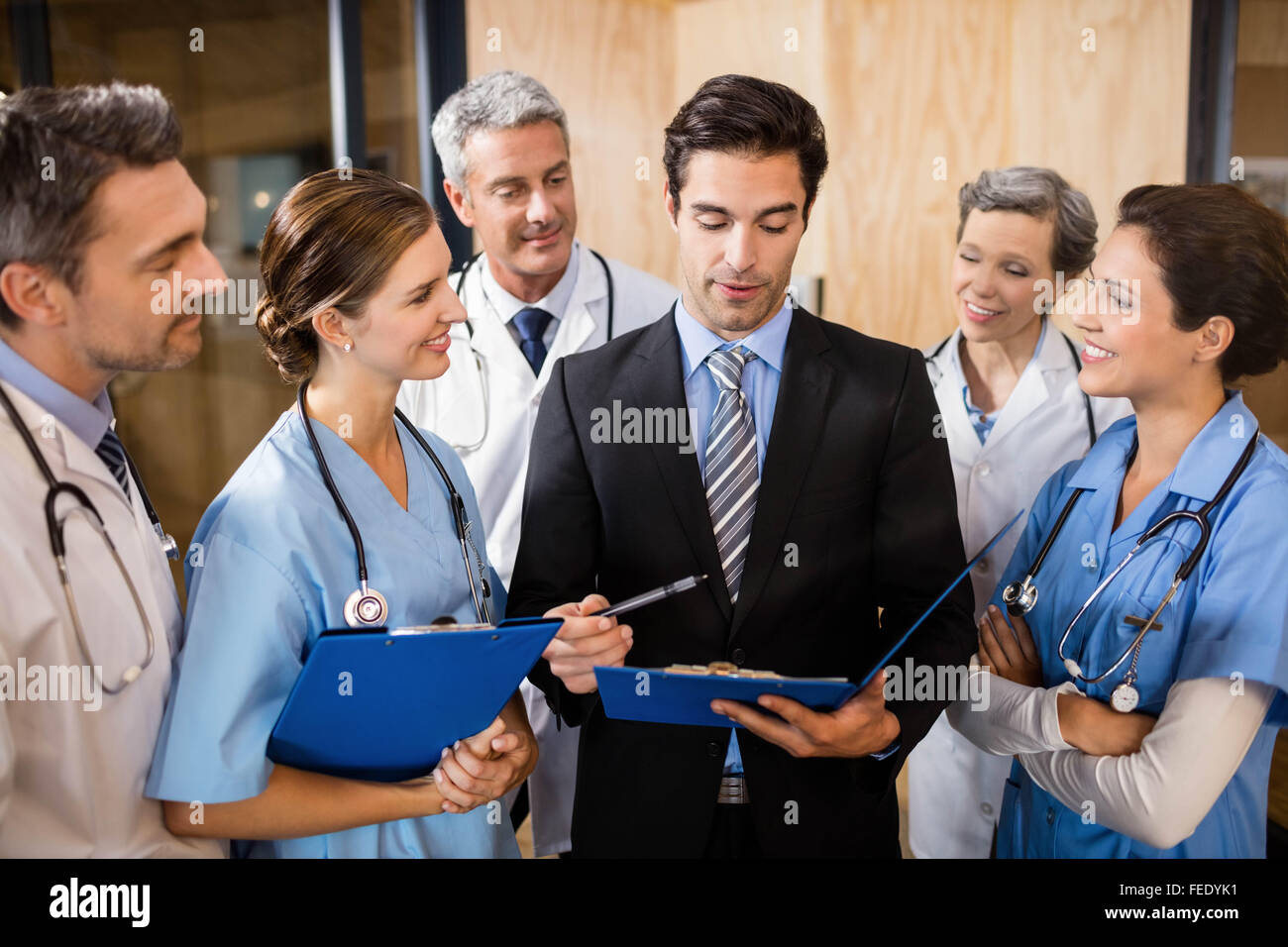 Medical team standing and talking Stock Photo - Alamy