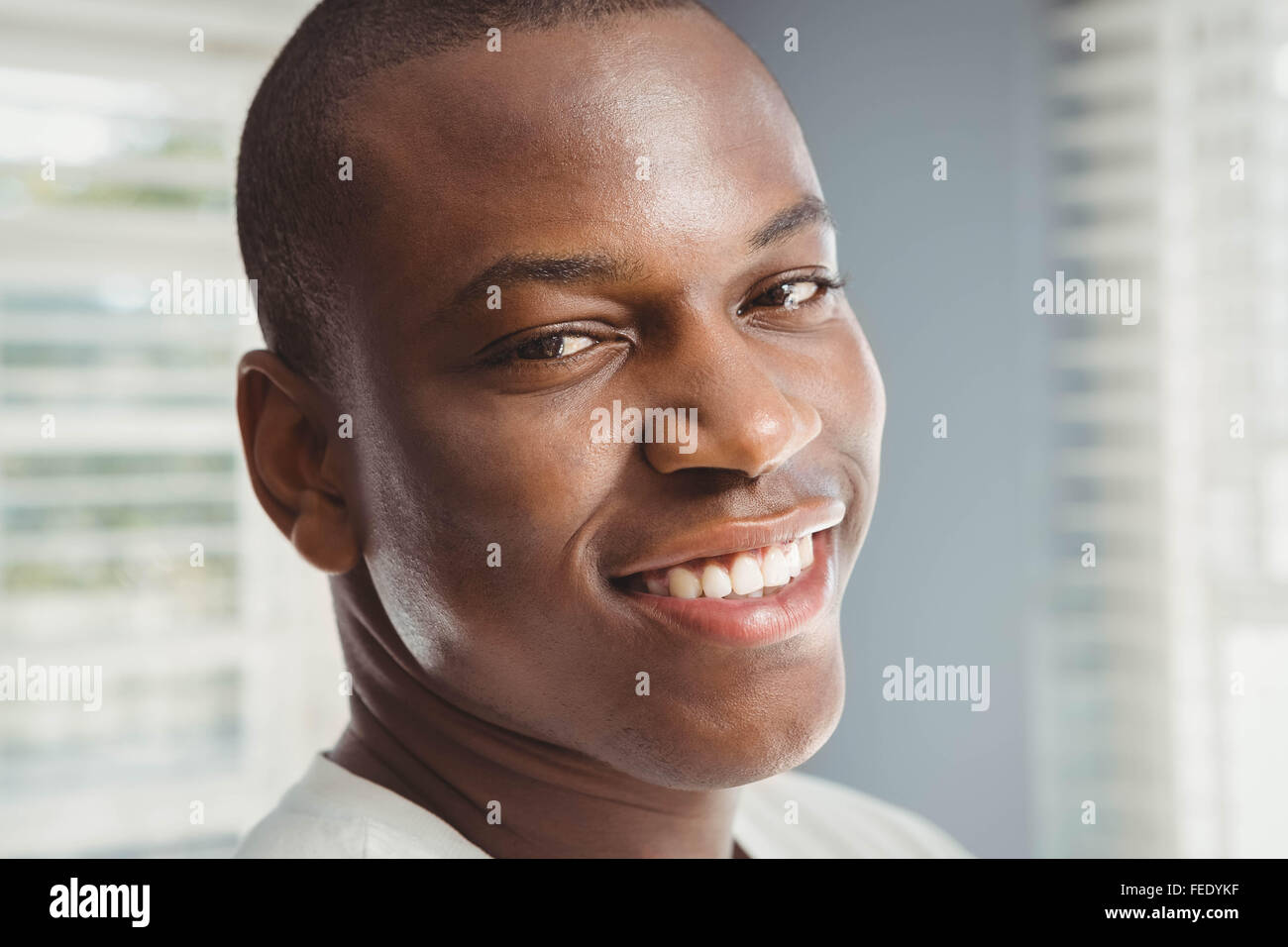 Smiling man looking through the window Stock Photo - Alamy
