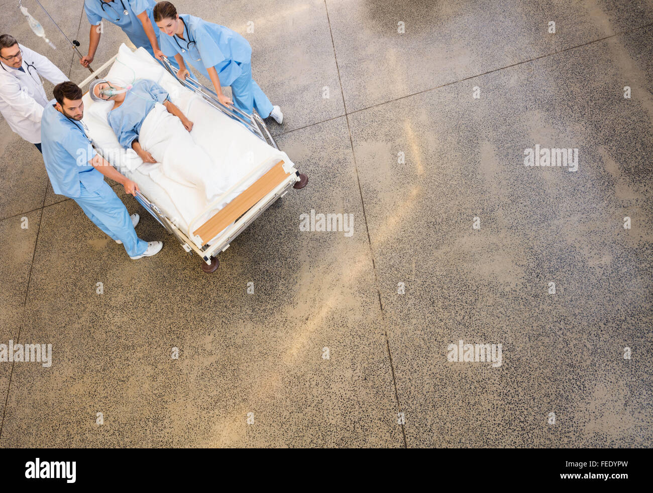 Medical team pushing patient on trolley Stock Photo - Alamy