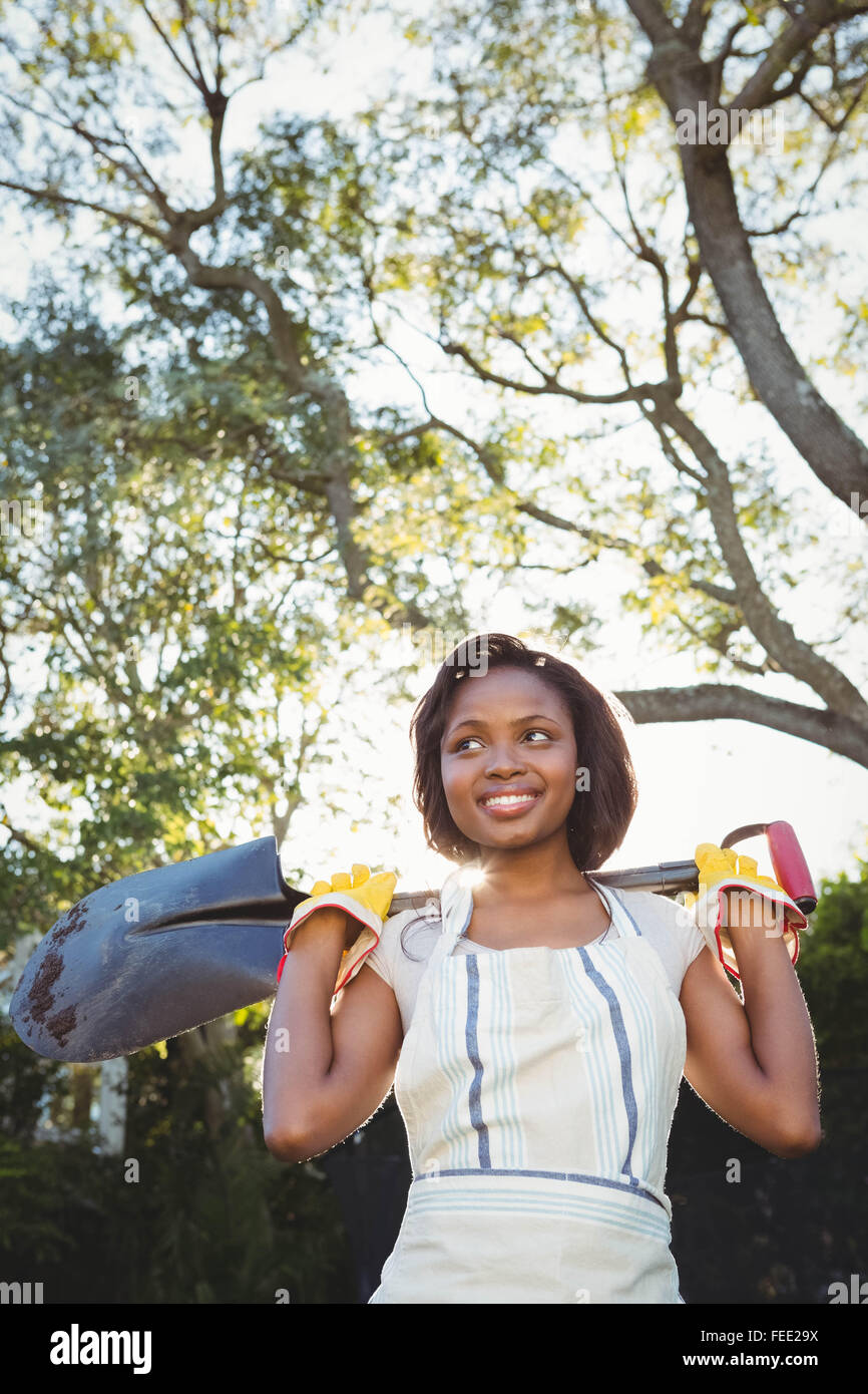 Pretty woman holding a shovel Stock Photo - Alamy