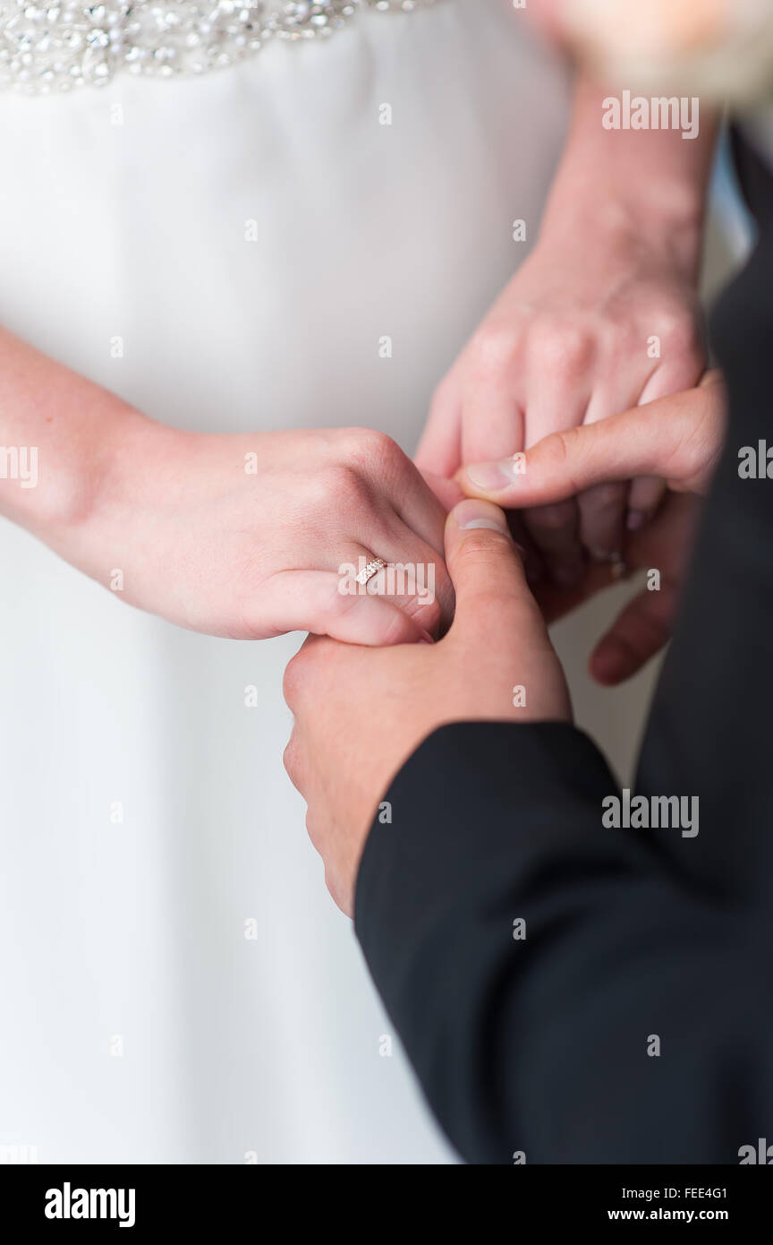 The bride and groom in wedding dresses standing next to each other and ...