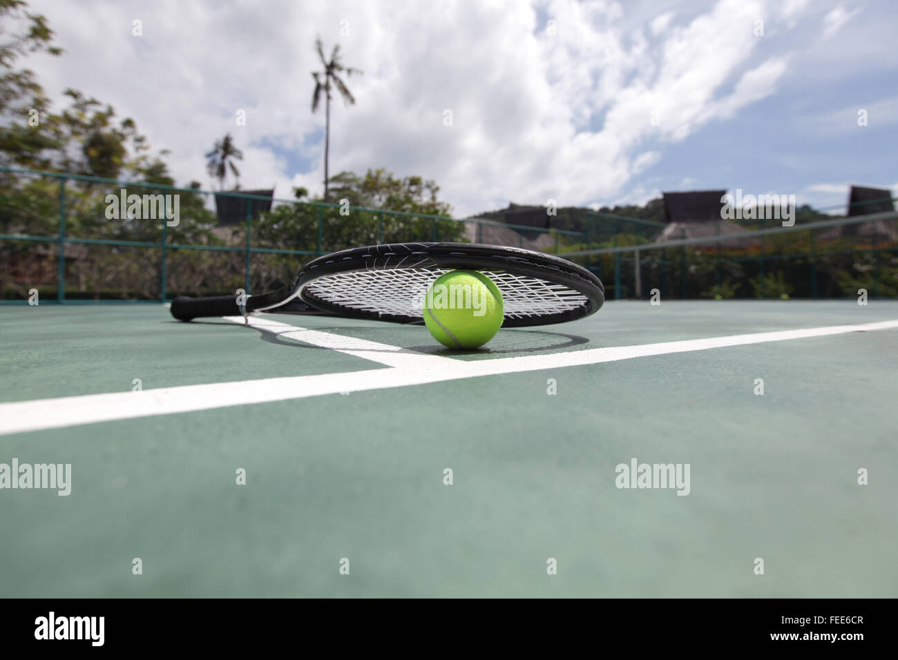 Tennis ball and racket on court close up Stock Photo - Alamy