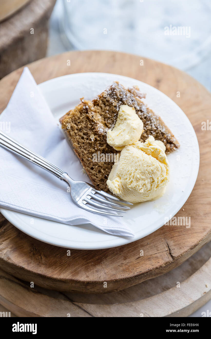 Cake with icecream on a plate with a fork Stock Photo - Alamy