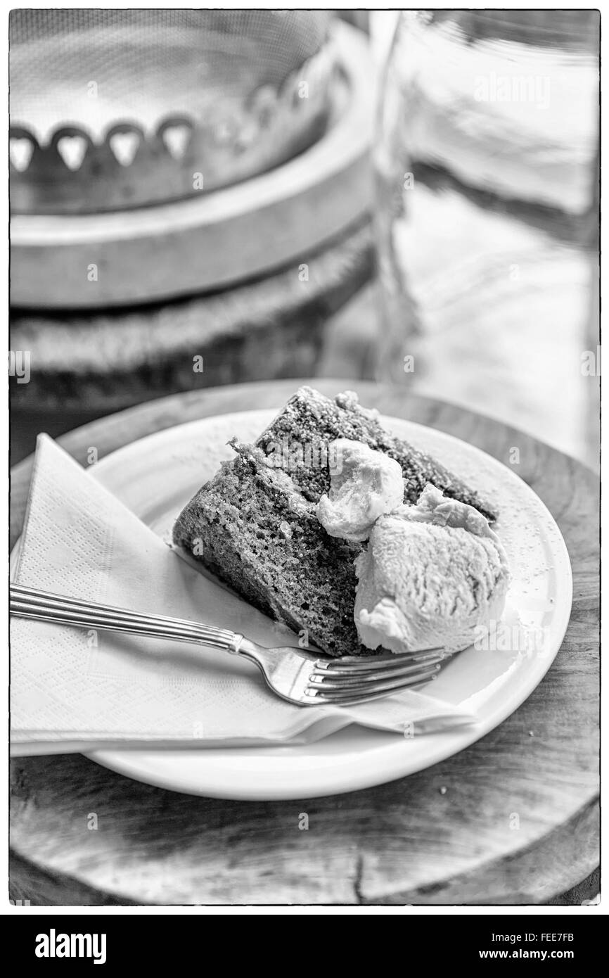 Cake with icecream on a plate with a fork Stock Photo - Alamy