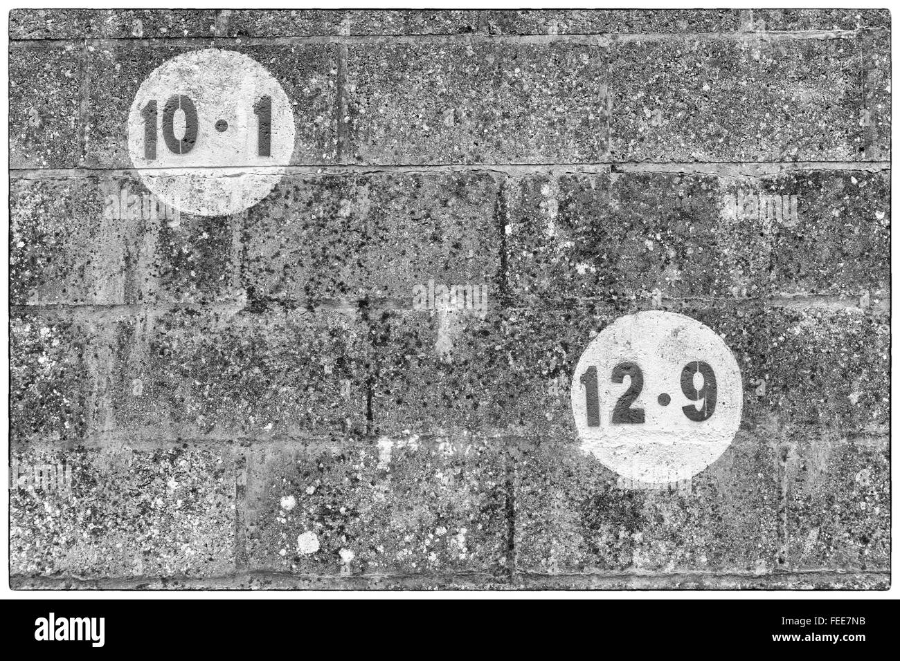 A black and white photo of numbers in a circle painted on dark ...
