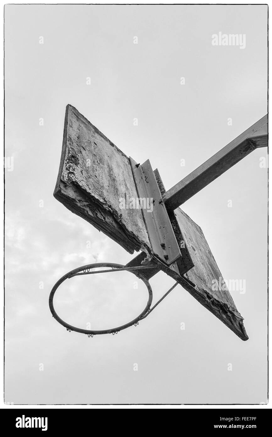 A black and white photo of an old basketball ring with a white wooden ...