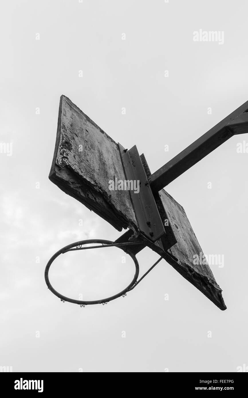A black and white photo of an old basketball ring with a white wooden ...