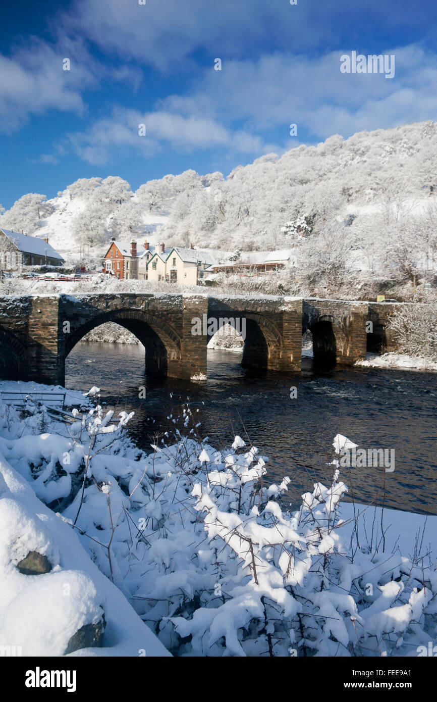 Carrog stone arched bridge and river Dee in snow Denbighshire North ...