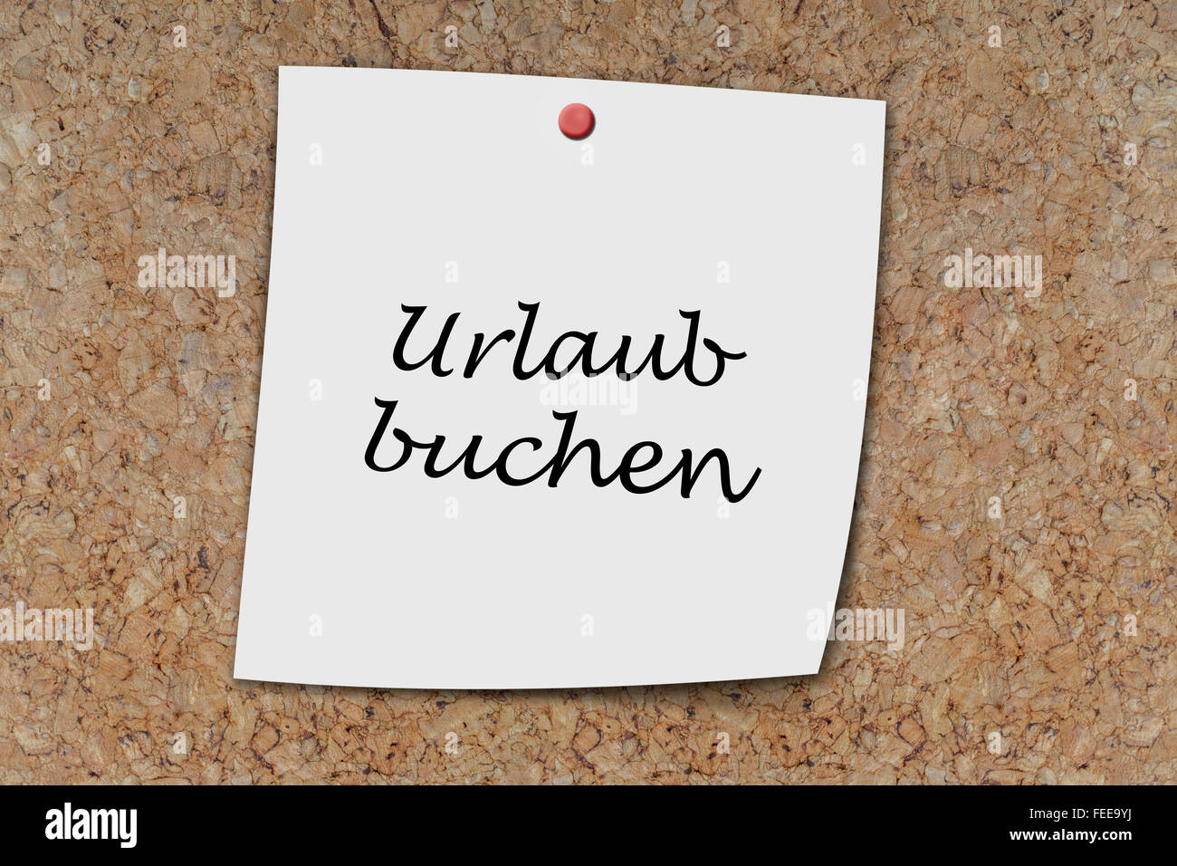 urlaub buchen (german book vavation) written on a memo pinned on a cork ...