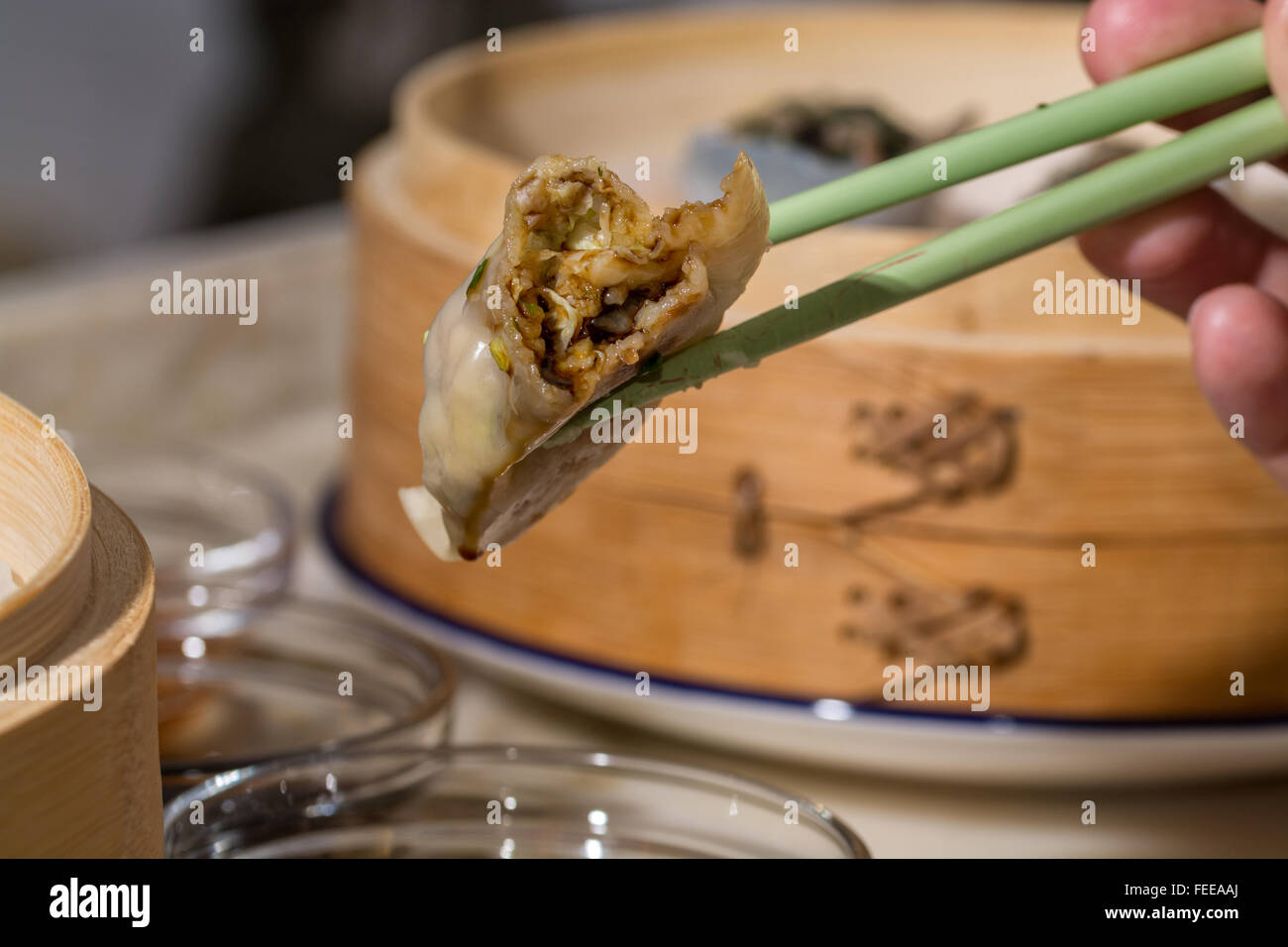 grabbing a dim sum with chinese chopsticks, traditional chinese starter ...