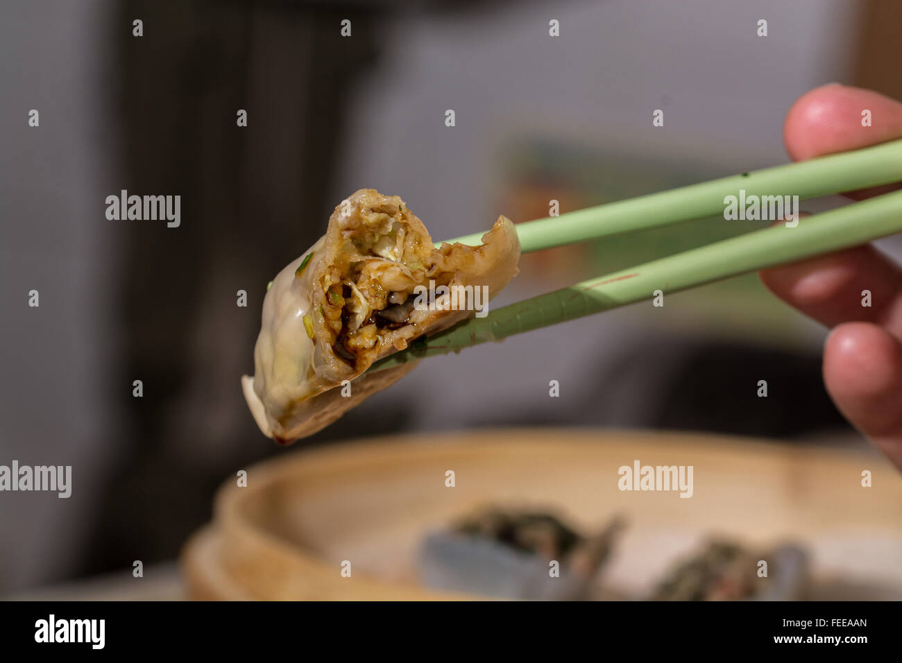 grabbing a dim sum with chinese chopsticks, traditional chinese starter ...