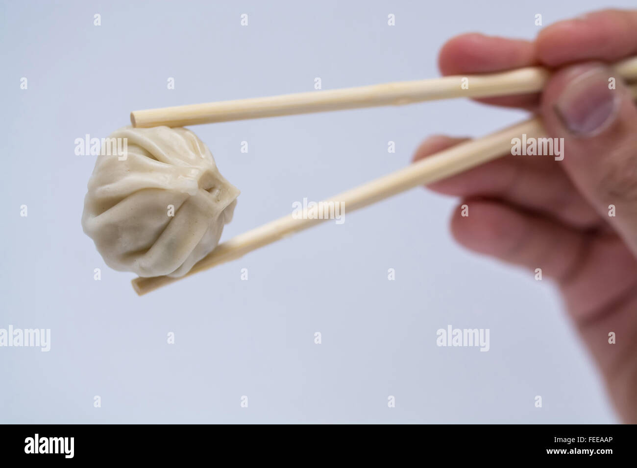 grabbing a dim sum with chinese chopsticks, traditional chinese starter ...