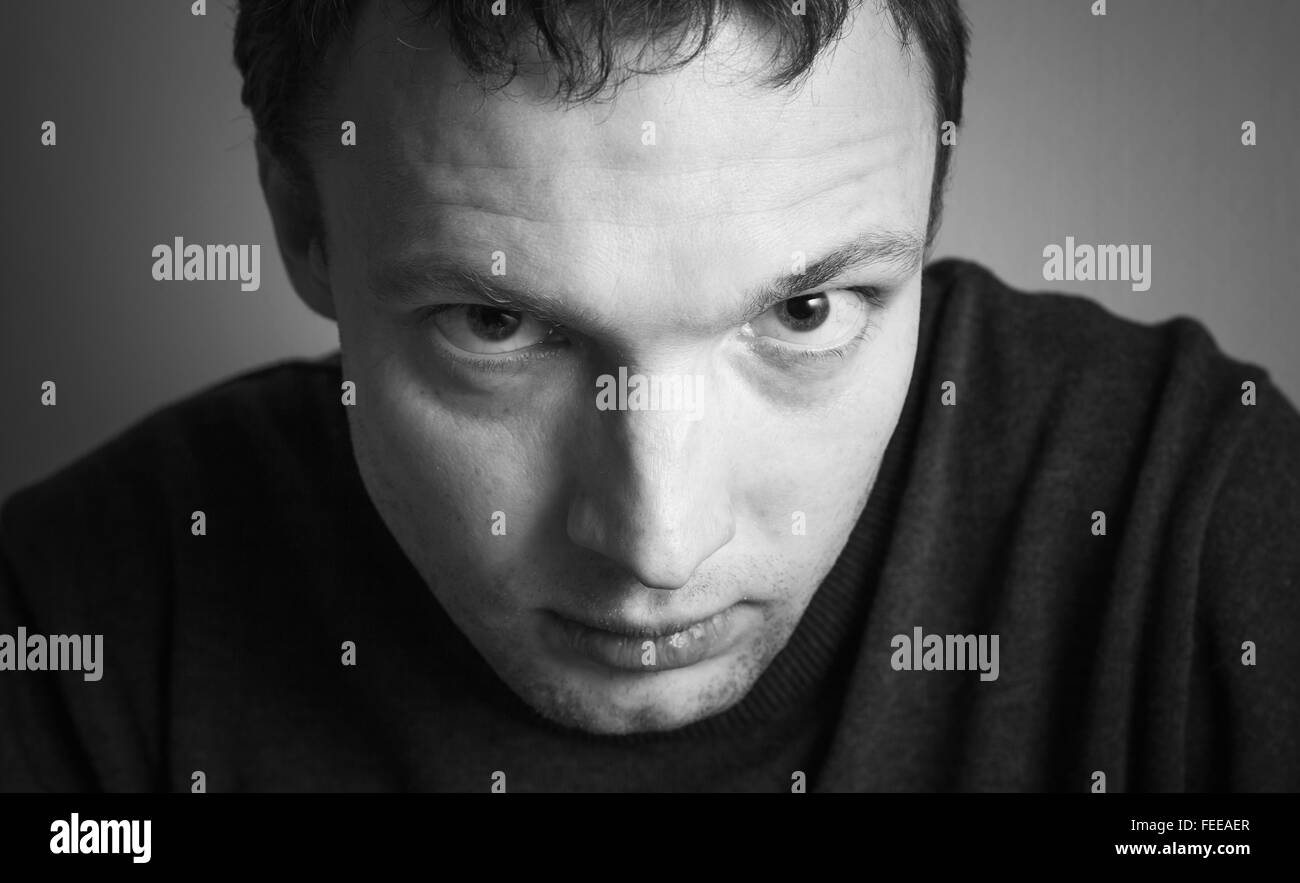 Young serious Caucasian man, close-up studio portrait, black and white ... Young serious Caucasian man, close-up studio portrait, black and white ...