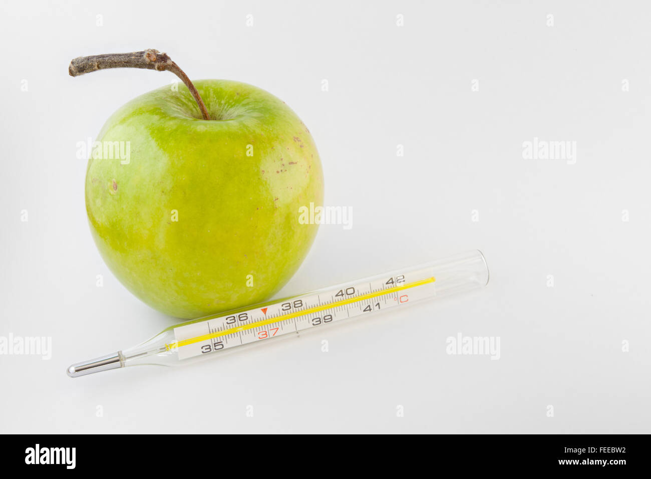 Green apple and thermometer Stock Photo - Alamy