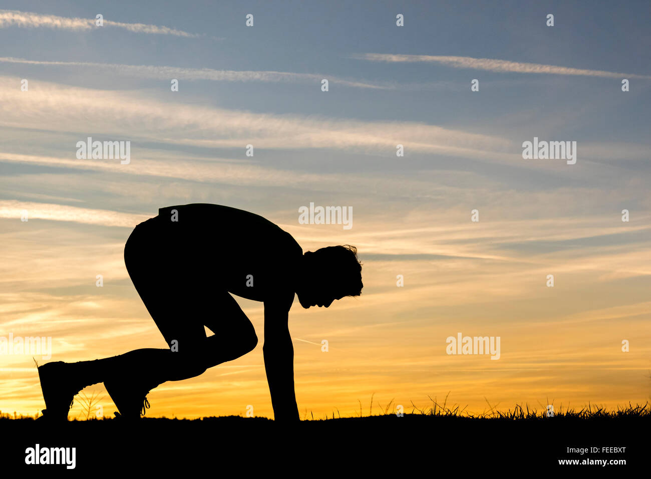 Silhouette, night sky, man crouching before sprint, athletics Stock ...