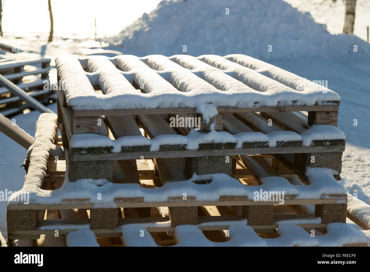 Box Pallets Covered in Snow stacked Stock Photo - Alamy