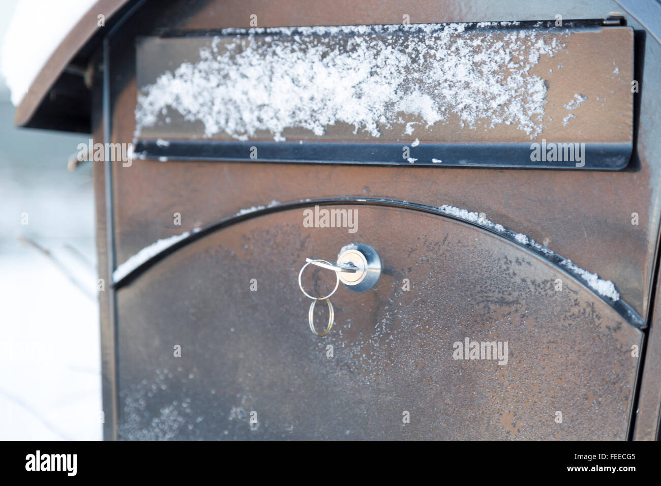 Key in black Letter Box with snow and frost Stock Photo - Alamy