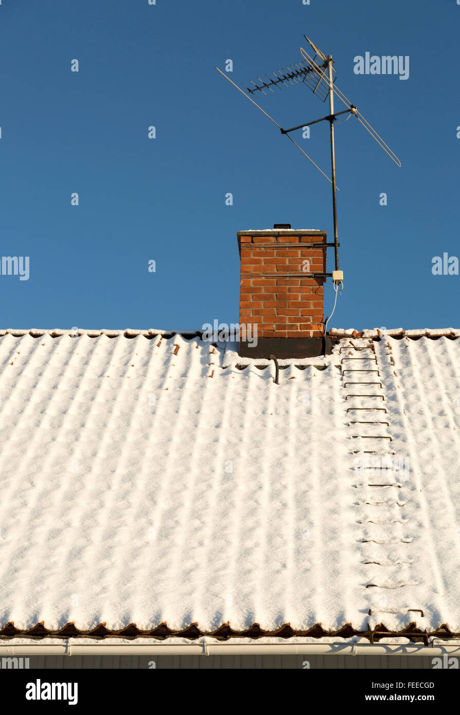 Snow Covered Roof with Chimney and TV Antenna Stock Photo - Alamy
