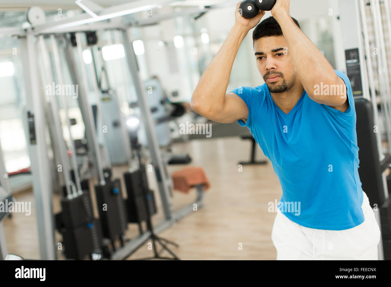 Young man training in the gym Stock Photo - Alamy