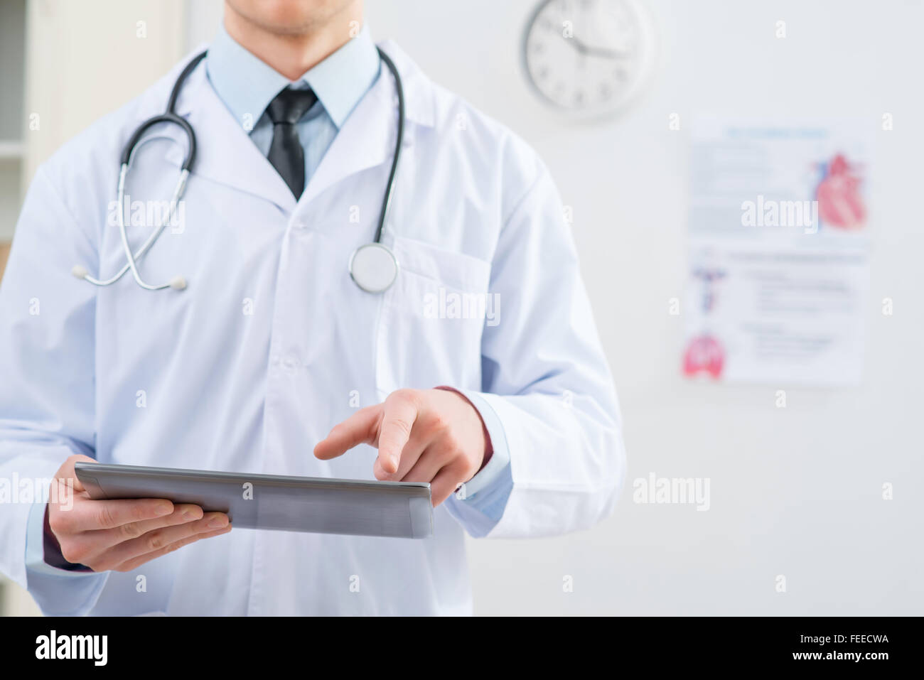 Professional doctor holding tablet Stock Photo - Alamy