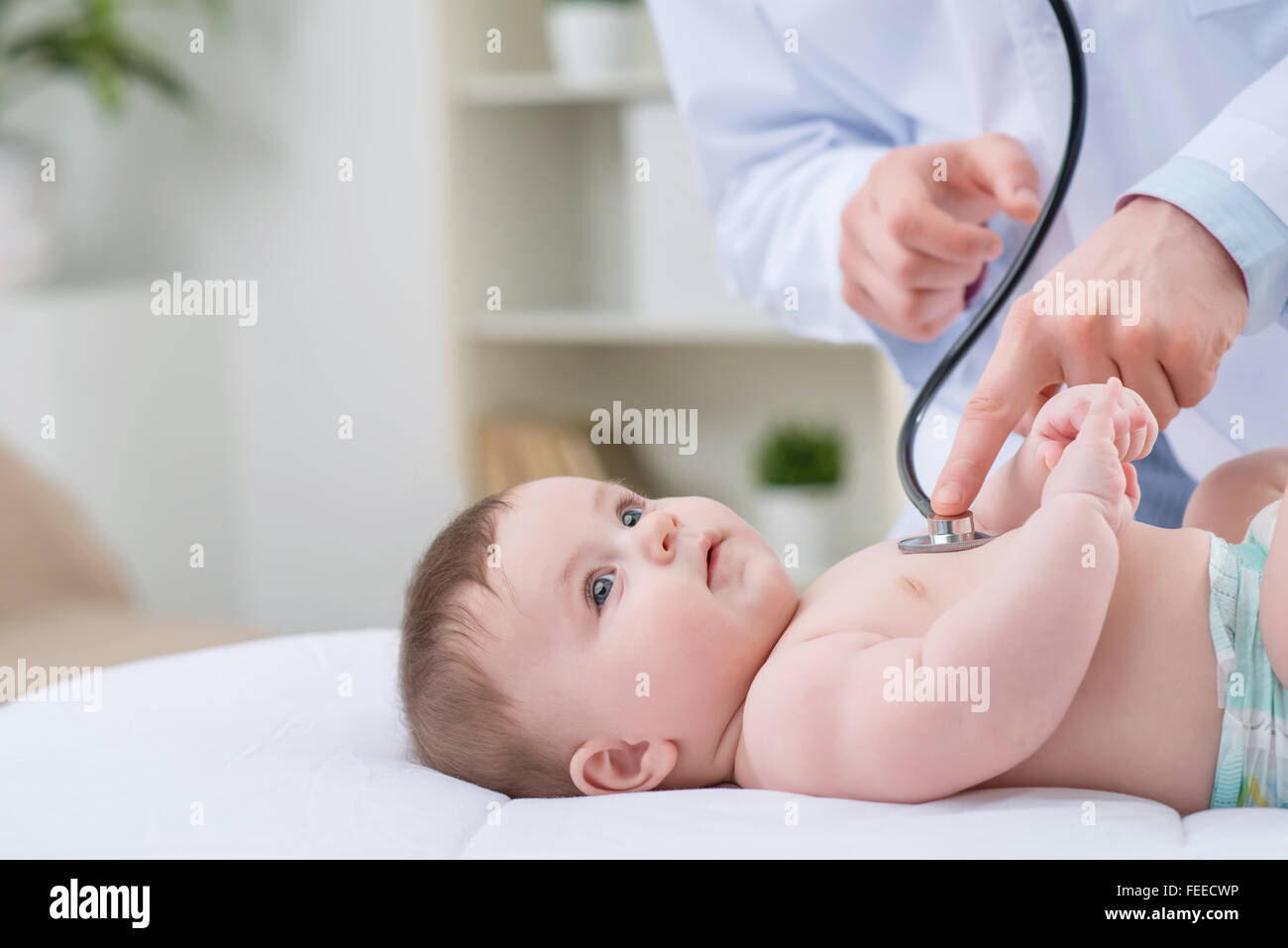 Professional pediatrician examining infant Stock Photo - Alamy