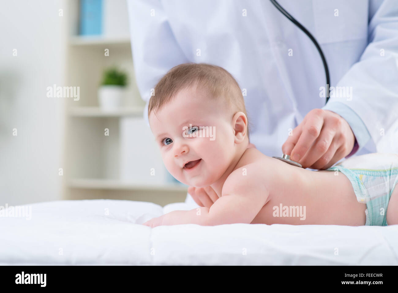 Professional pediatrician examining infant Stock Photo - Alamy