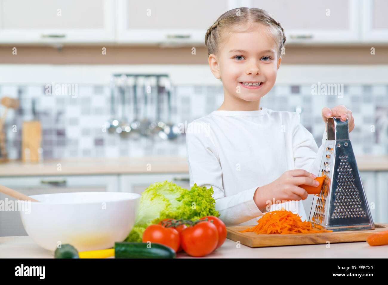 Little girl cooking in the kitchen Stock Photo - Alamy