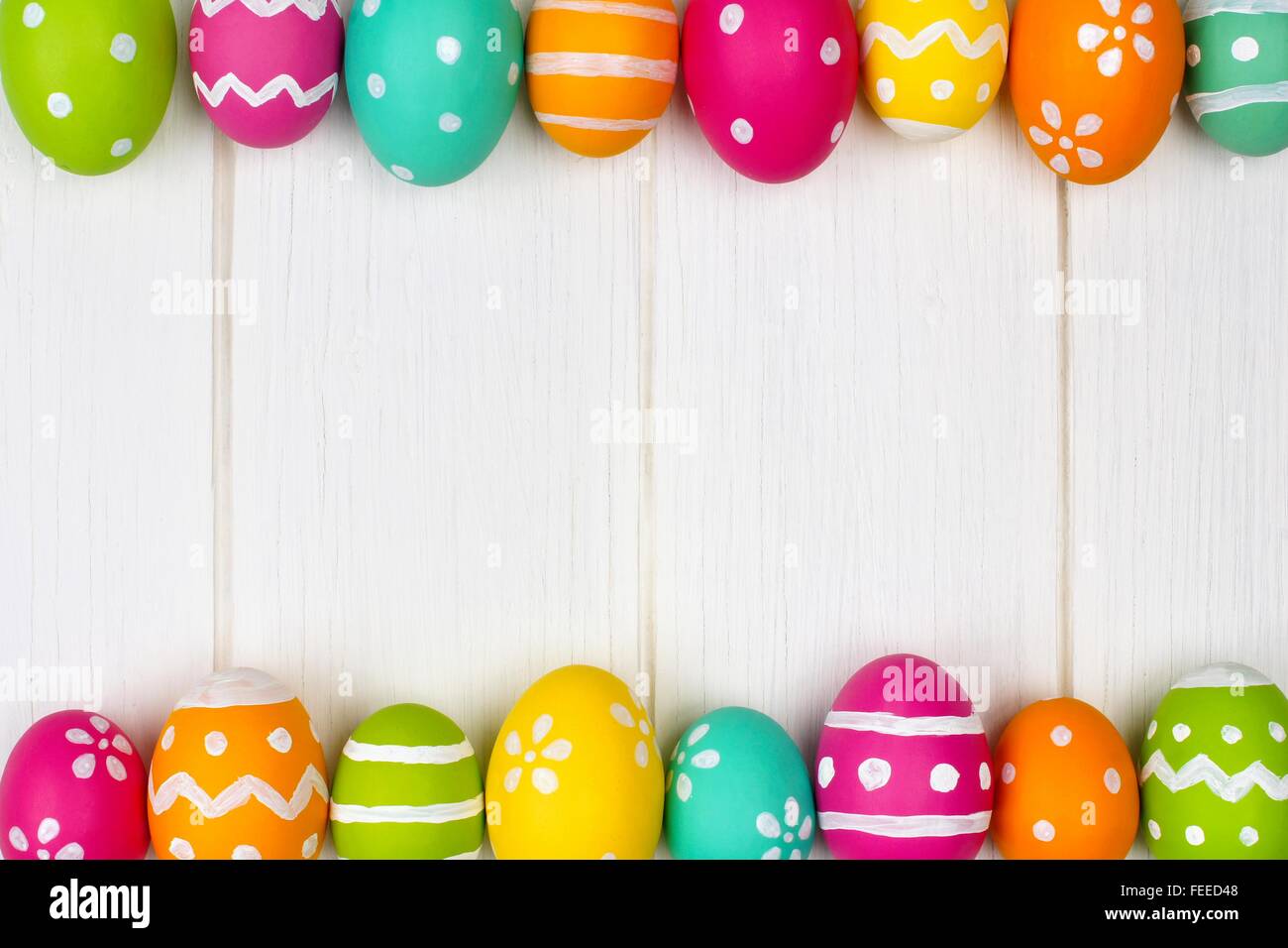 Colorful Easter egg frame against a white wood background Stock Photo ...