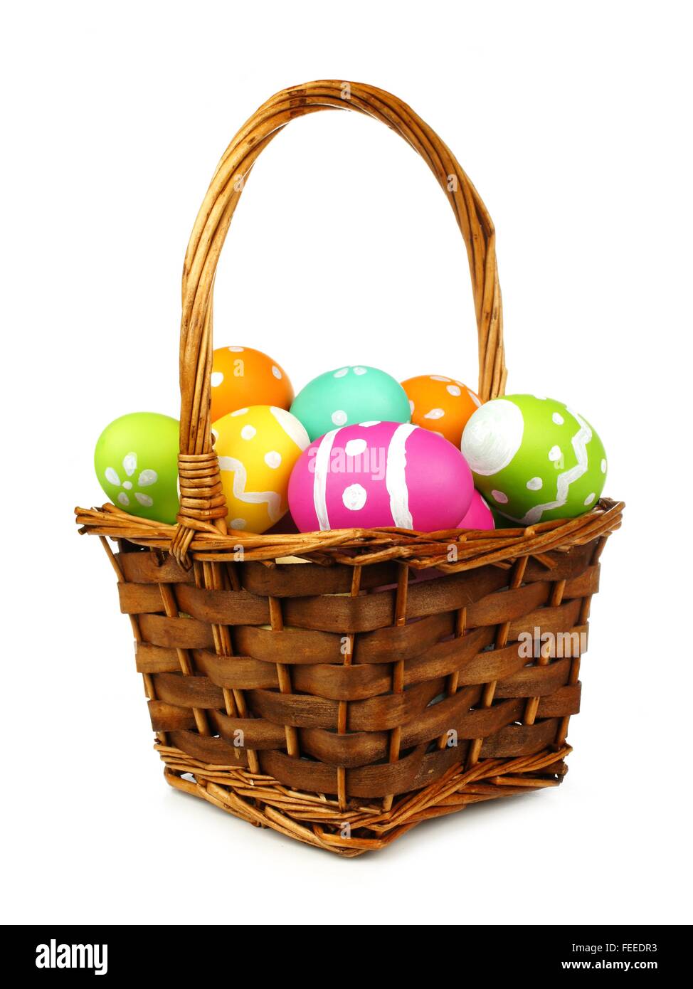 Easter basket filled with colorful eggs on a white background Stock ...