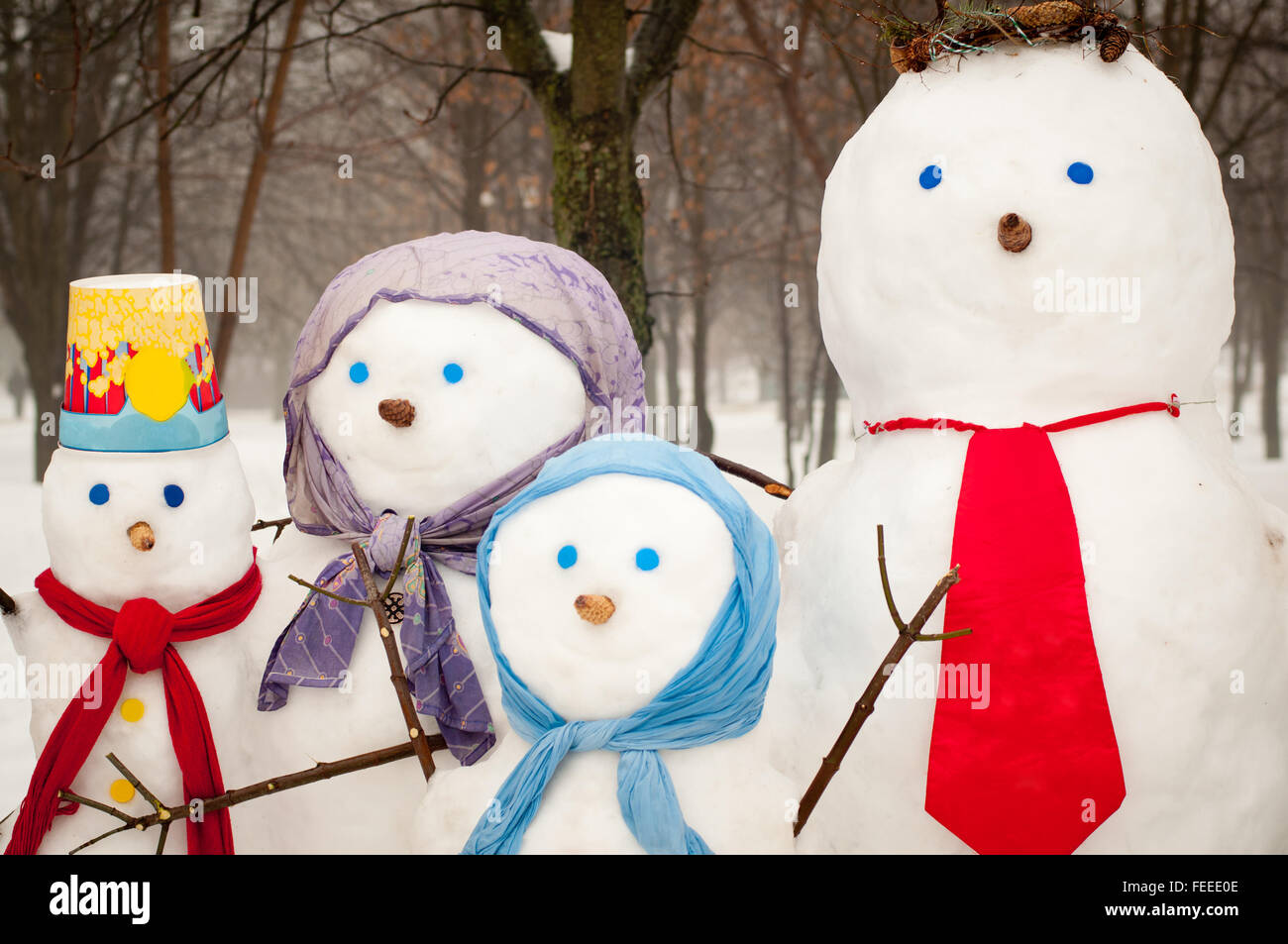 Four snowmen in winter in scarf and hats Stock Photo - Alamy