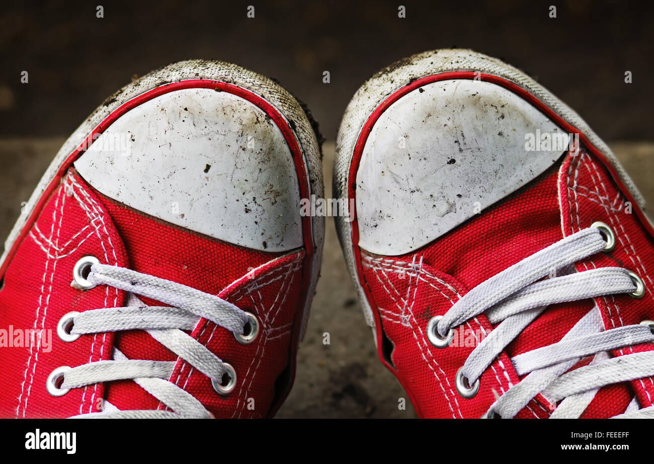 Feet in dirty red sneakers outdoors. Making first step Stock Photo - Alamy