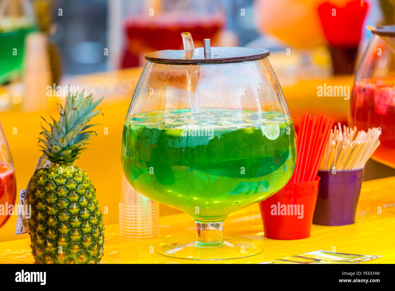 Carnival, booth with alcoholic mix drinks, big bowls with fruit and ...