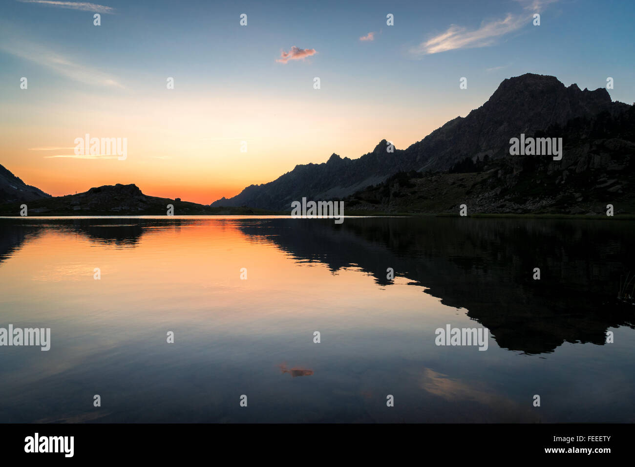 Sunset reflected on a lake in the Pyrénées, France Stock Photo - Alamy