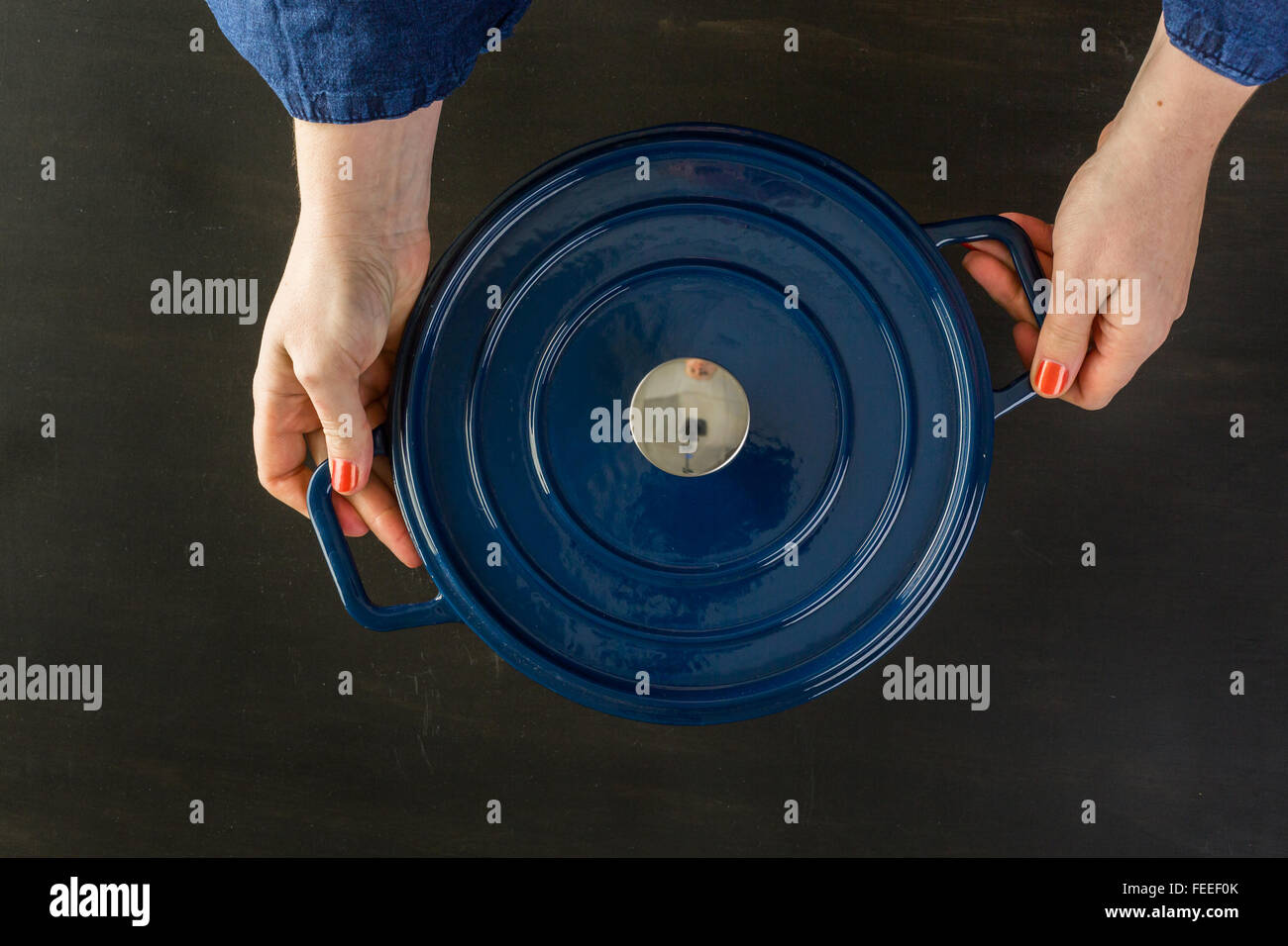 Enameled blue cast iron covered dutch oven on black wood table Stock ...