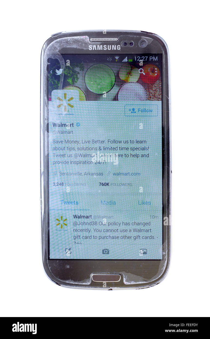 The Walmart Twitter page on a smartphone screen photographed against a ...