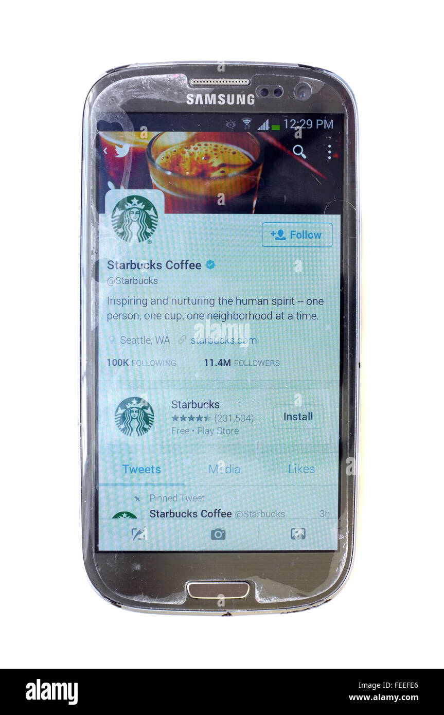 The Starbucks Twitter page on a smartphone screen photographed against ...