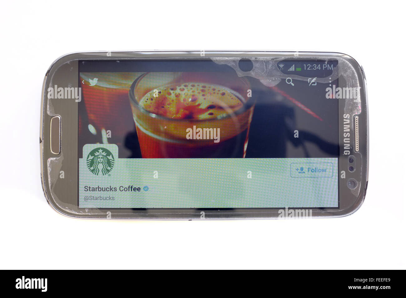 The Starbucks Twitter page on a smartphone screen photographed against ...