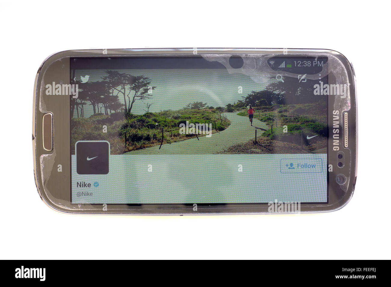 The Nike Twitter page on a smartphone screen photographed against a ...